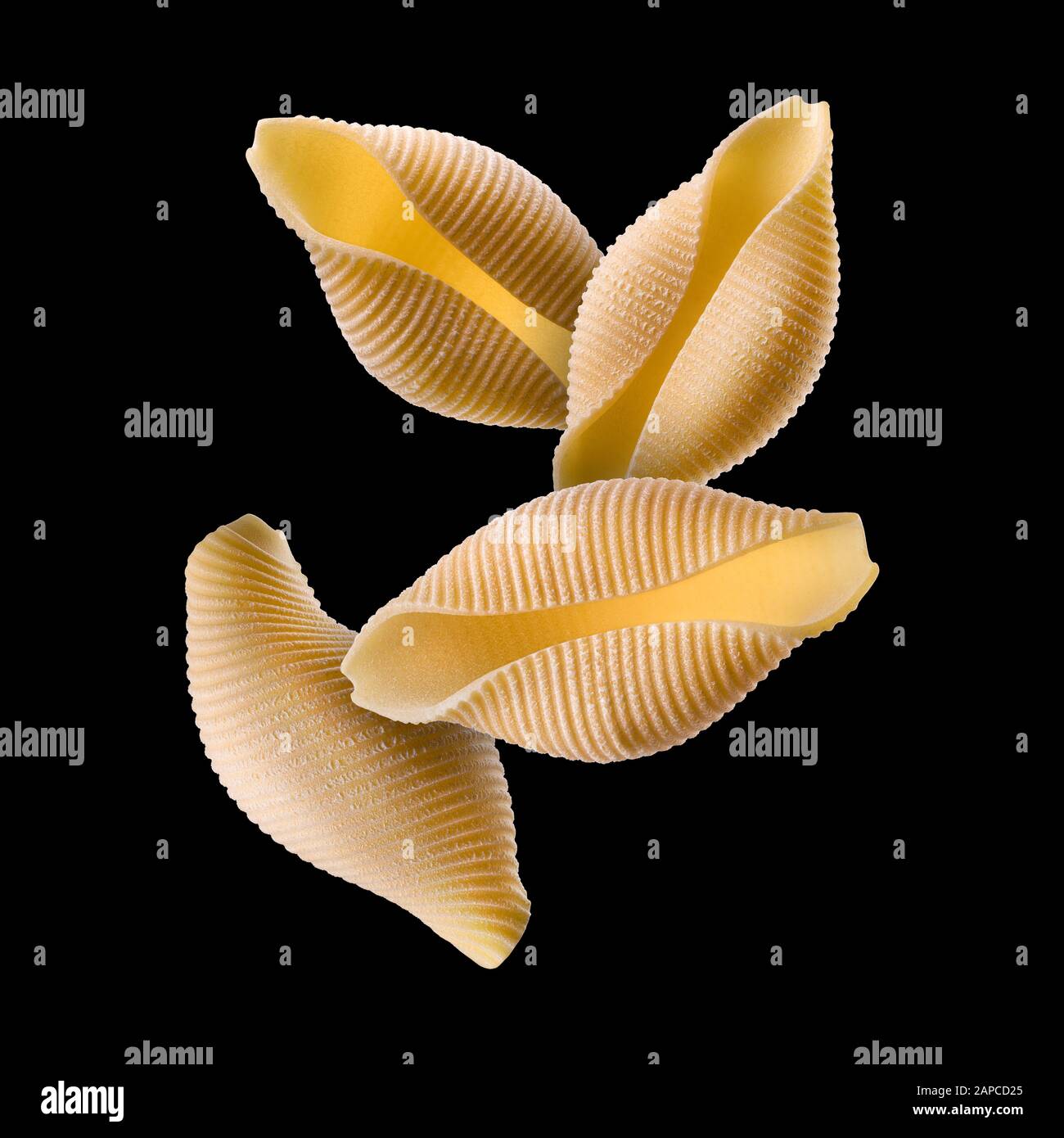 Conchiglie pasta shell composition isolated on black background Stock ...