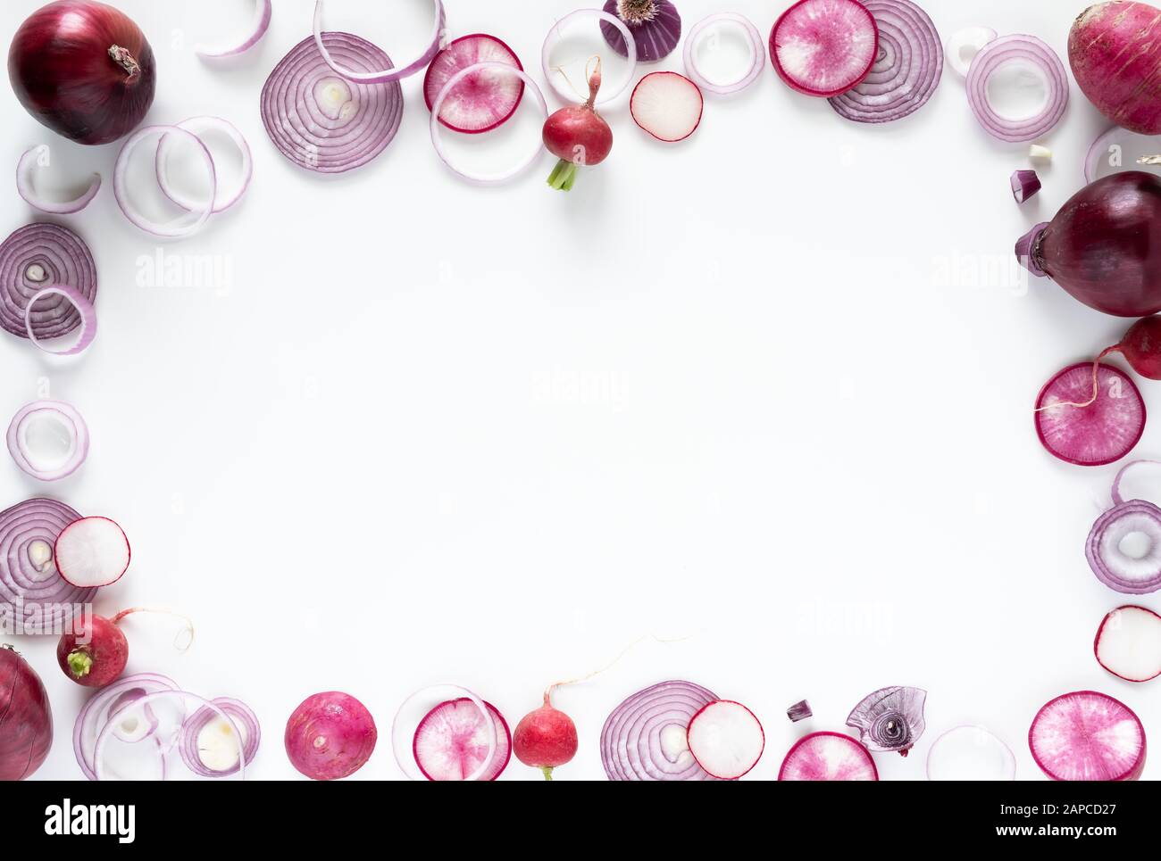 A top down view of a border frame made of red onion slices, daikon and ...