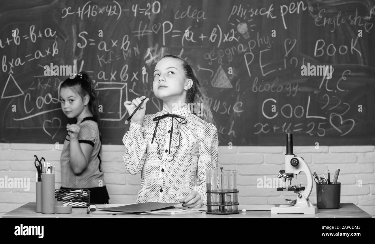 Little girls scientist work with microscope. Little girls in school lab ...