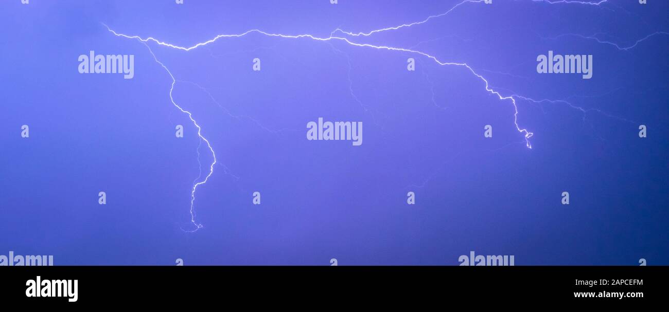 Long lightning bolt with side branches is high up in the sky Stock ...