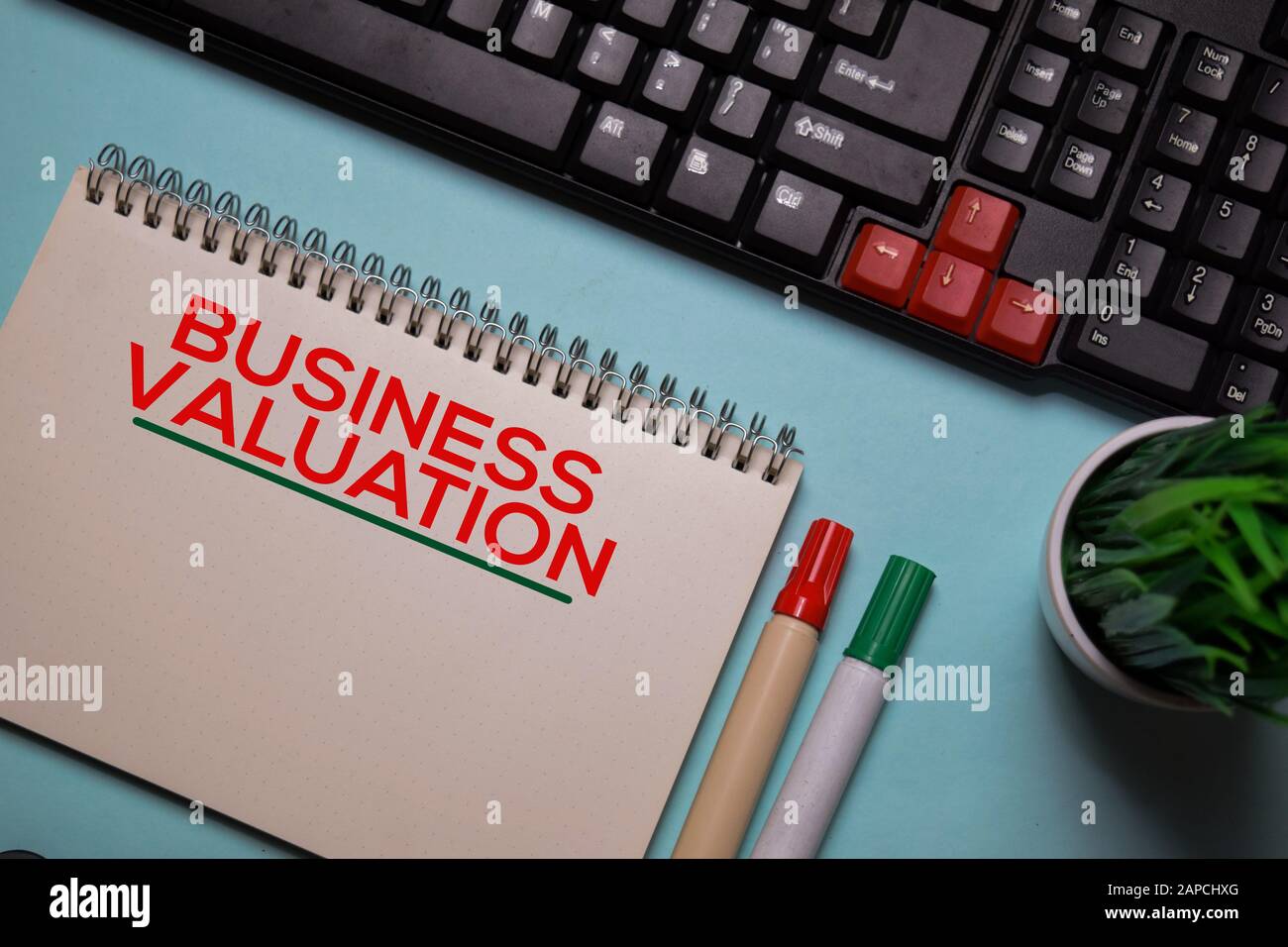Business Valuation write on a book isolated on office desk Stock Photo ...