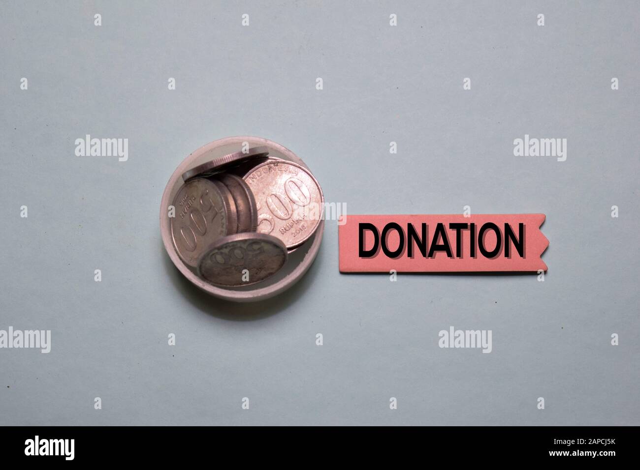 Indonesian Rupiah and Donation write on a sticky note isolated on ...