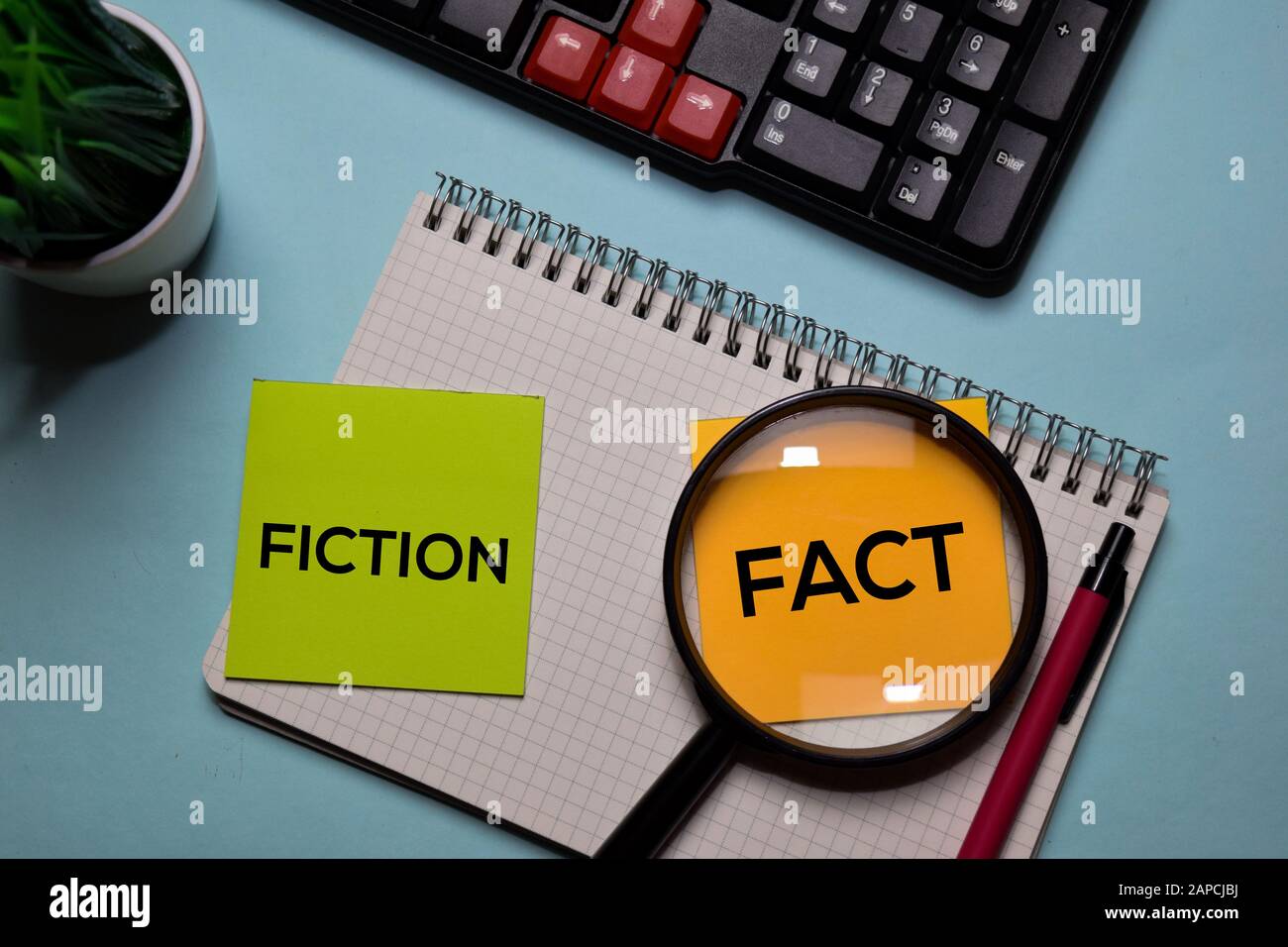Fiction and Fact write on a sticky note isolated on office desk Stock ...