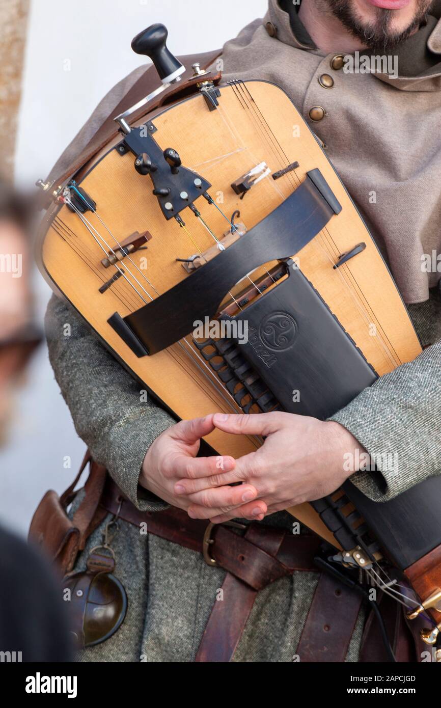 Medieval costume character band musician plays the hurdy-gurdy string ...