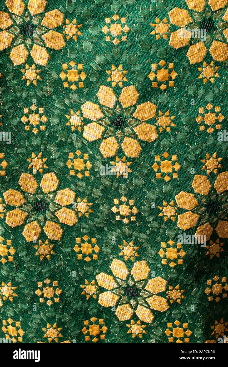 Close up view of Traditional green and golden medieval fabric design ...