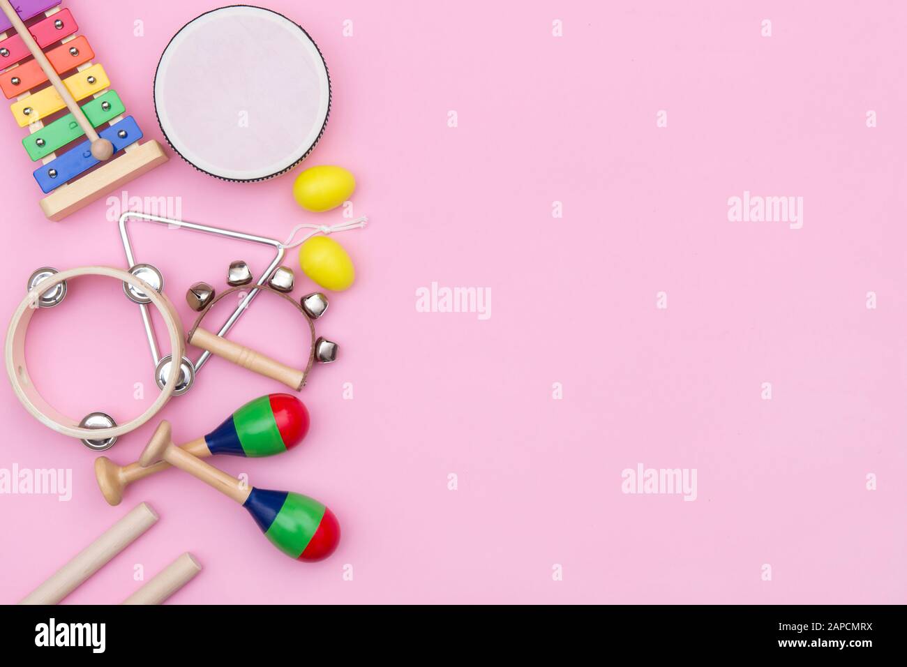 Musical instruments on pink background Stock Photo - Alamy