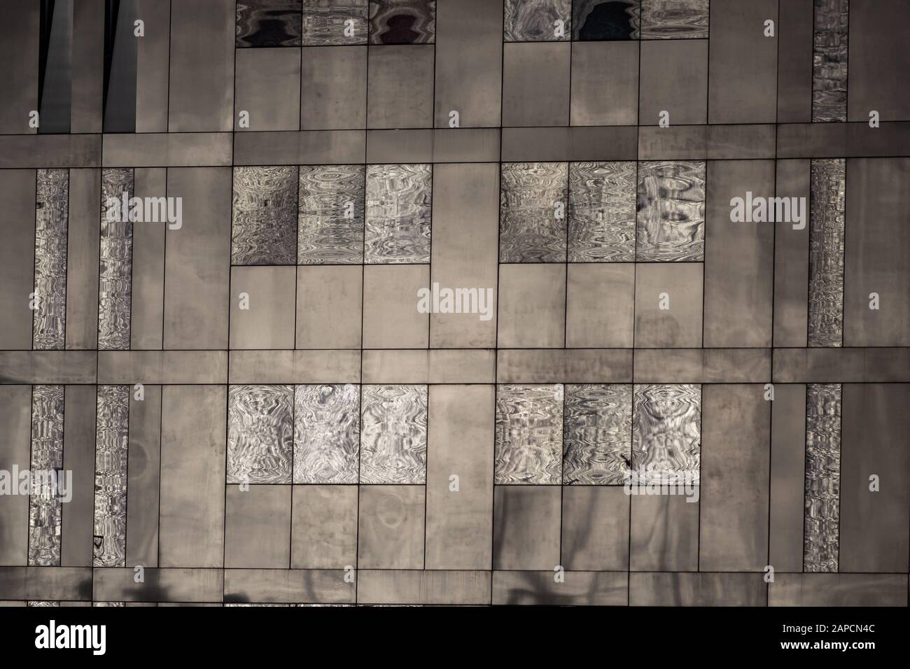 Windows of building with water ripples reflected at Mann island,Canning ...