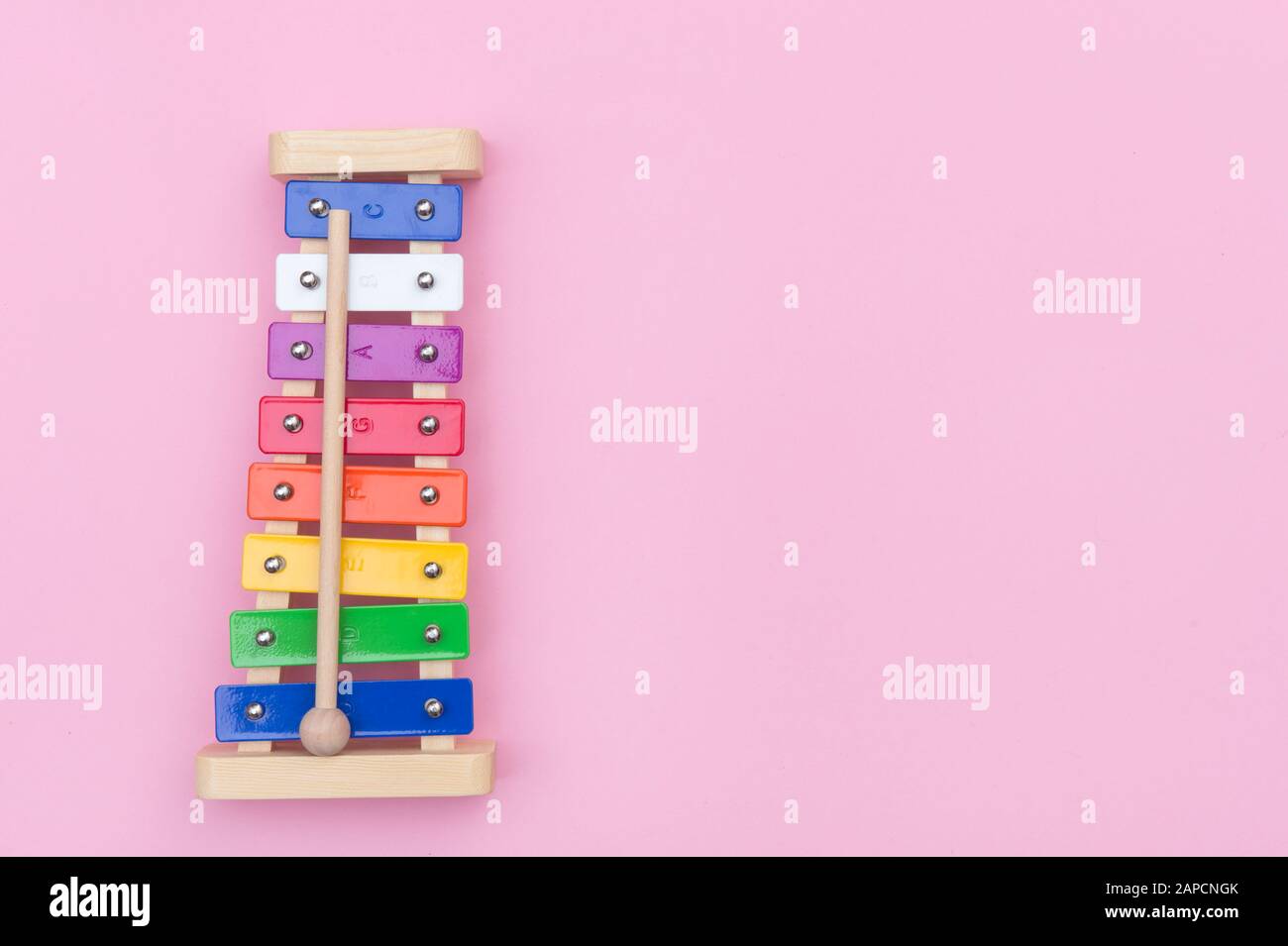 Colour xylophone isolated on pink background Stock Photo - Alamy