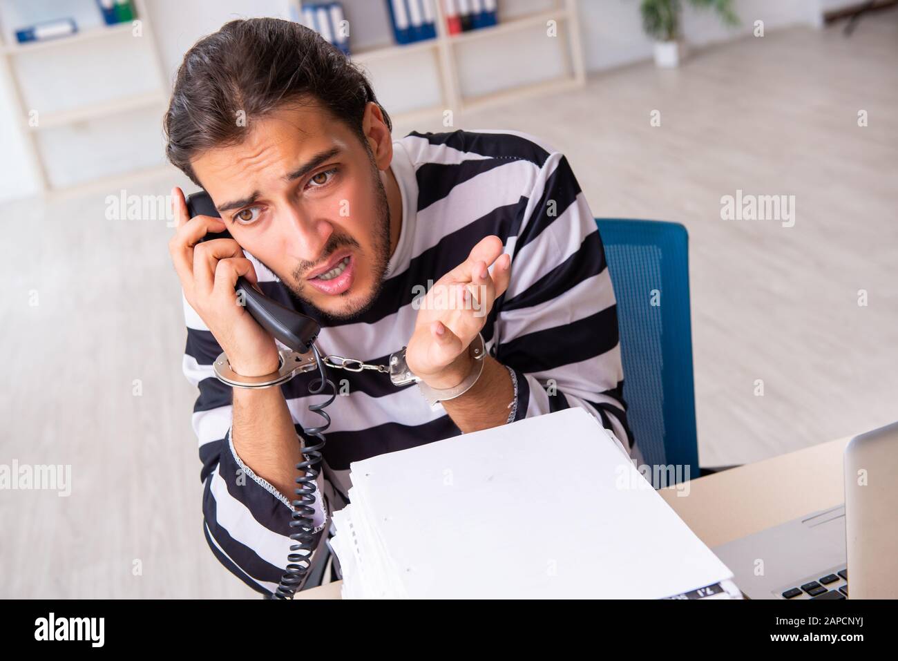 The young employee feeling like prisoner at work Stock Photo - Alamy