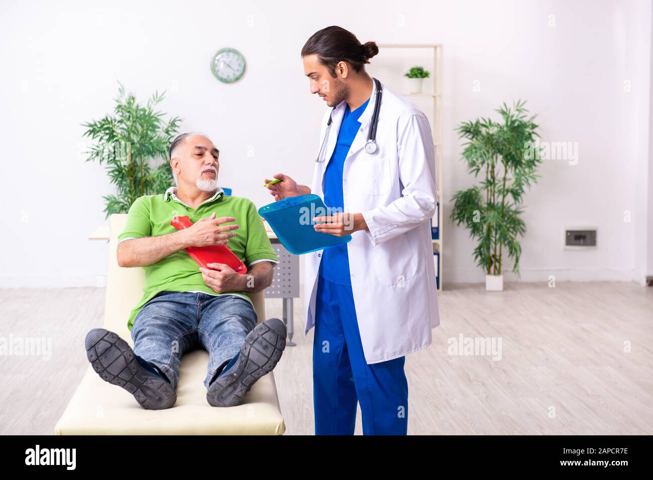 The old man visiting young male doctor gastroenterologist Stock Photo ...