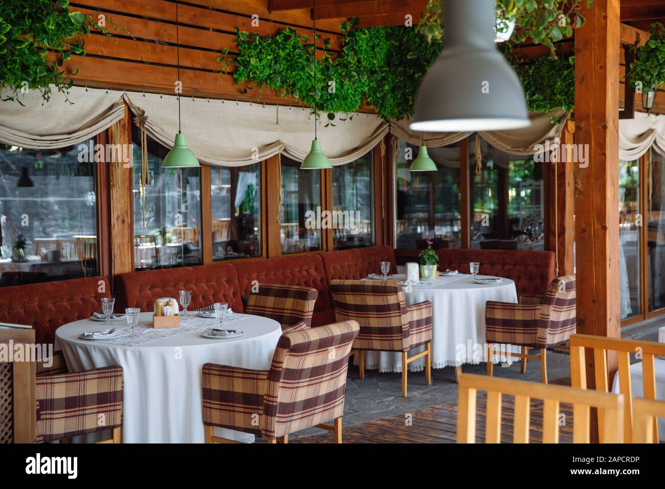The cozy interior of the restaurant.There are soft sofas with tables ...