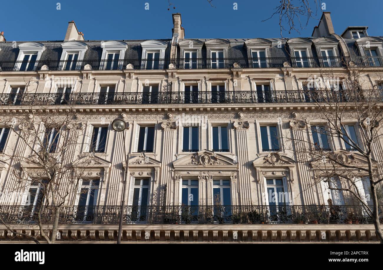 Traditional French house with typical balconies and windows. Paris ...