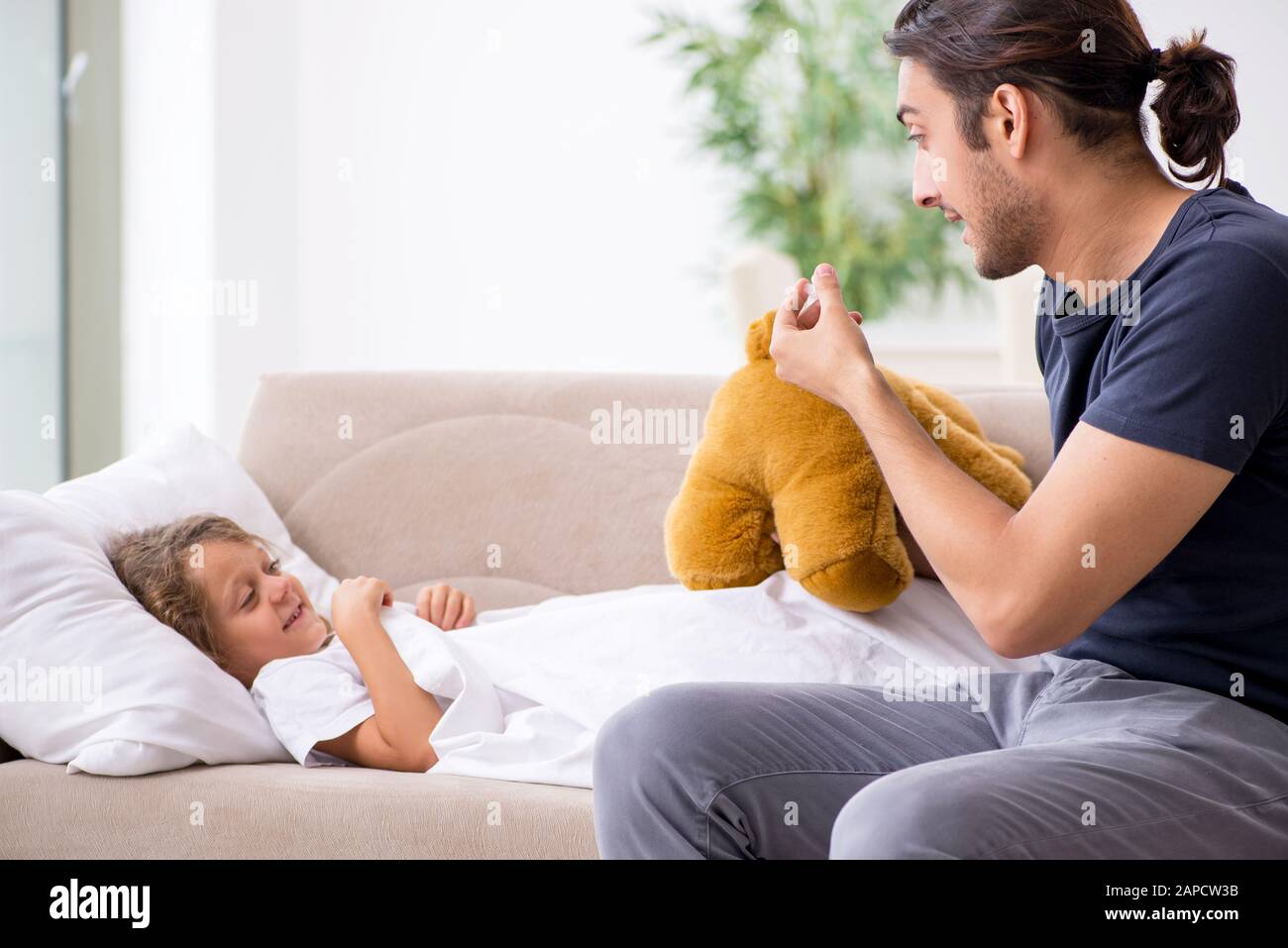 The father taking care of his ill daughter Stock Photo - Alamy