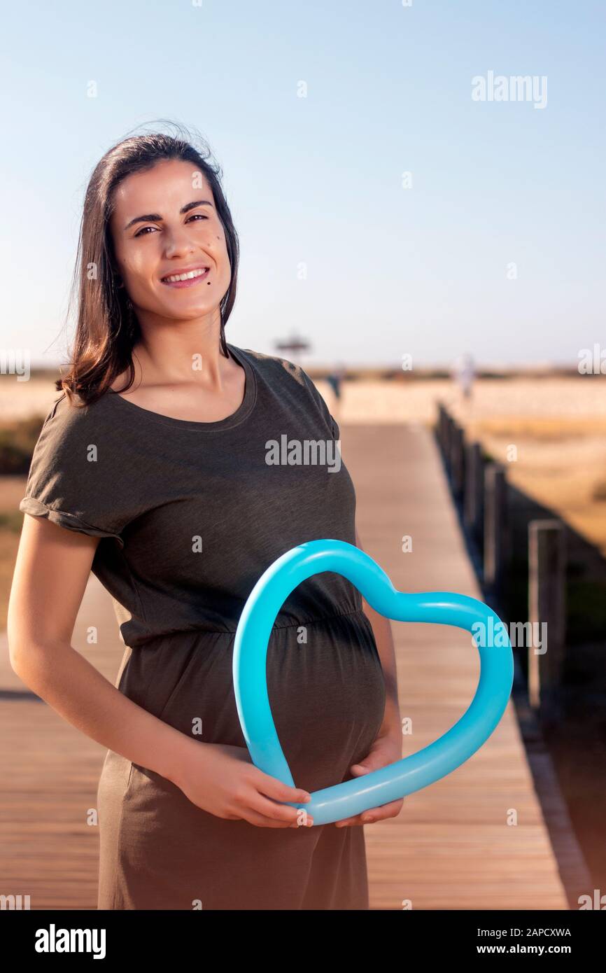 Young woman poses blue balloon hi-res stock photography and images - Alamy