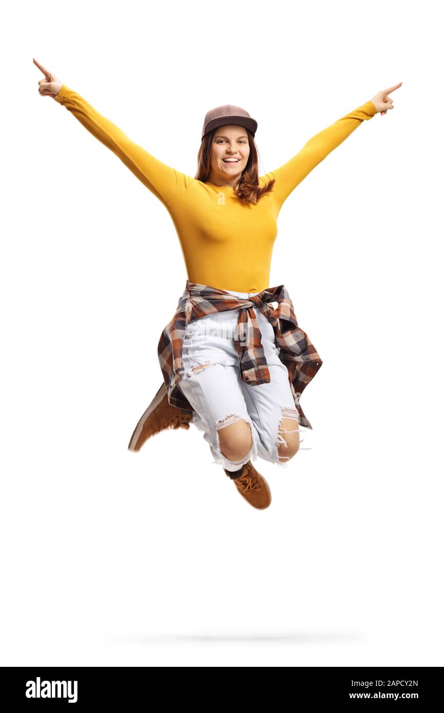 Young female in casual clothes with a cap jumping isolated on white ...