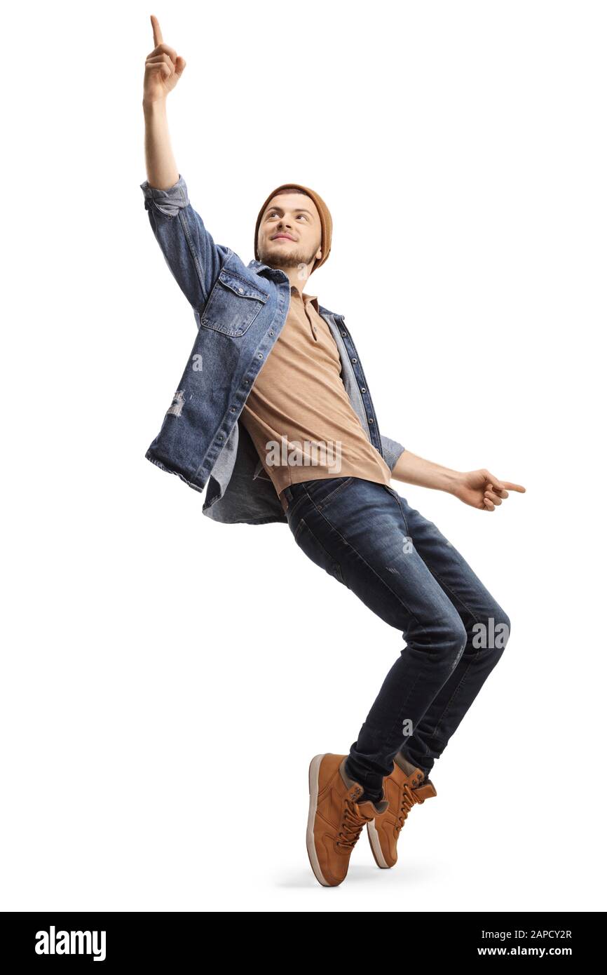 Full length shot of a young man dancing and looking up isolated on ...