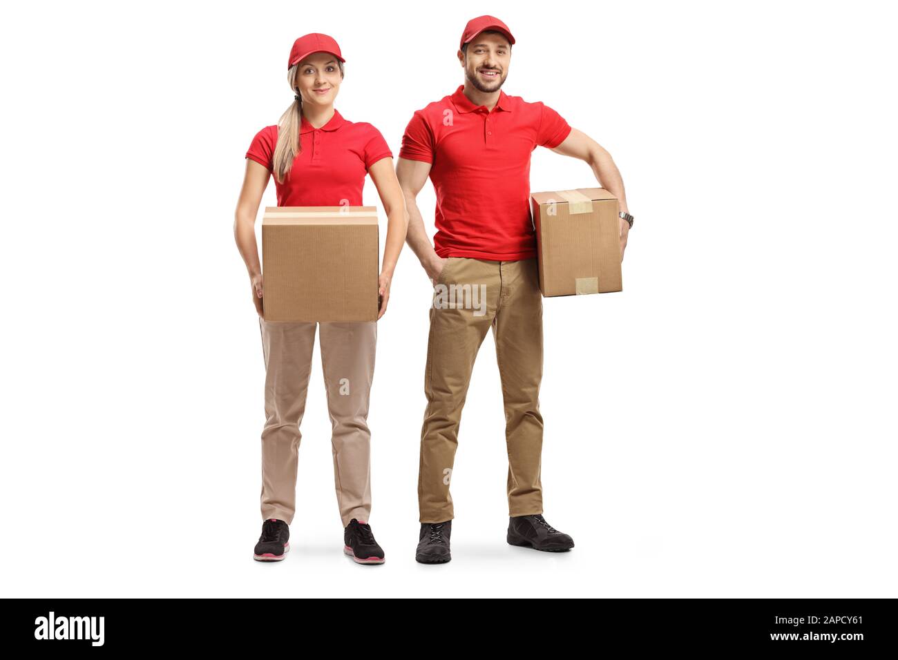 Full length portrait of a delivery male and female in uniforms holding ...