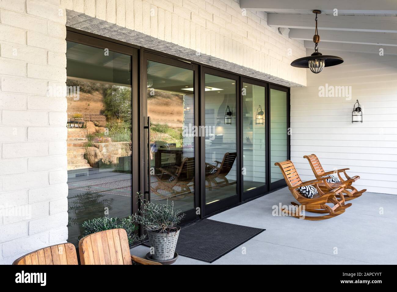Front porch with modern commercial pivot door Stock Photo - Alamy