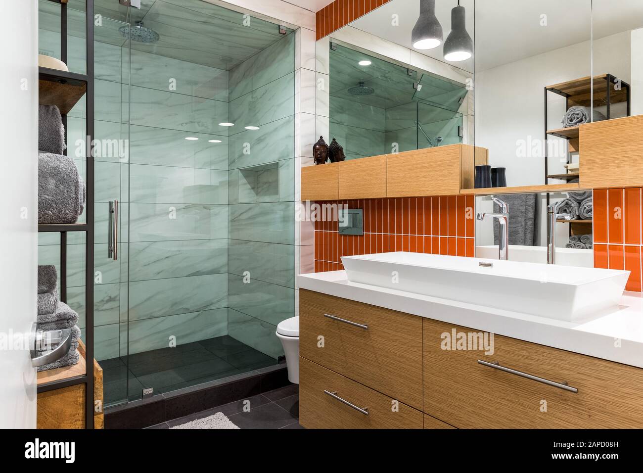 Modern bathroom with orange tile and walk in shower Stock Photo - Alamy