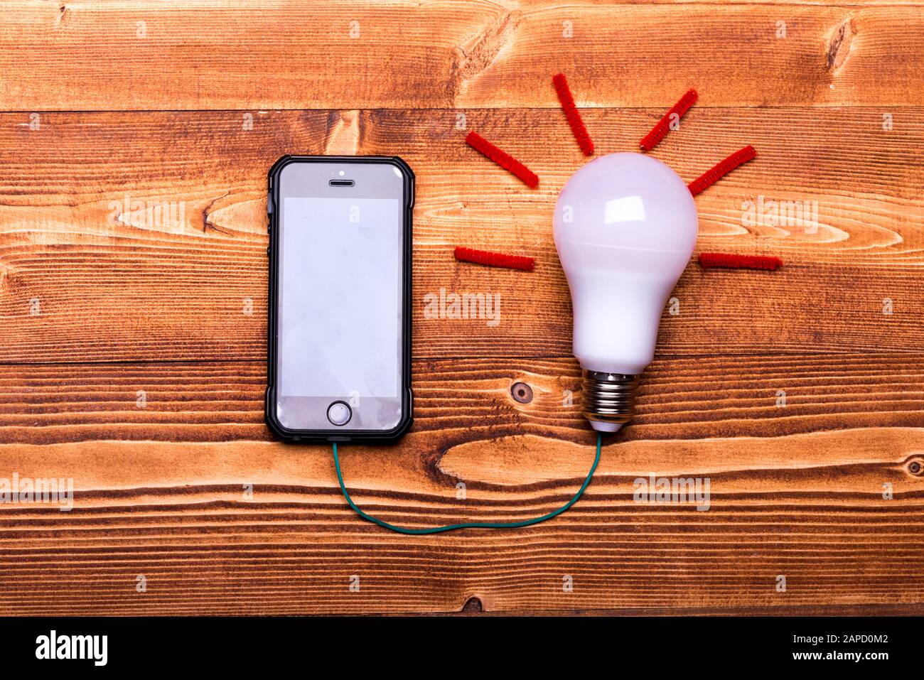 Gadget and idea symbol. Mobile phone and light bulb connected with wire ...