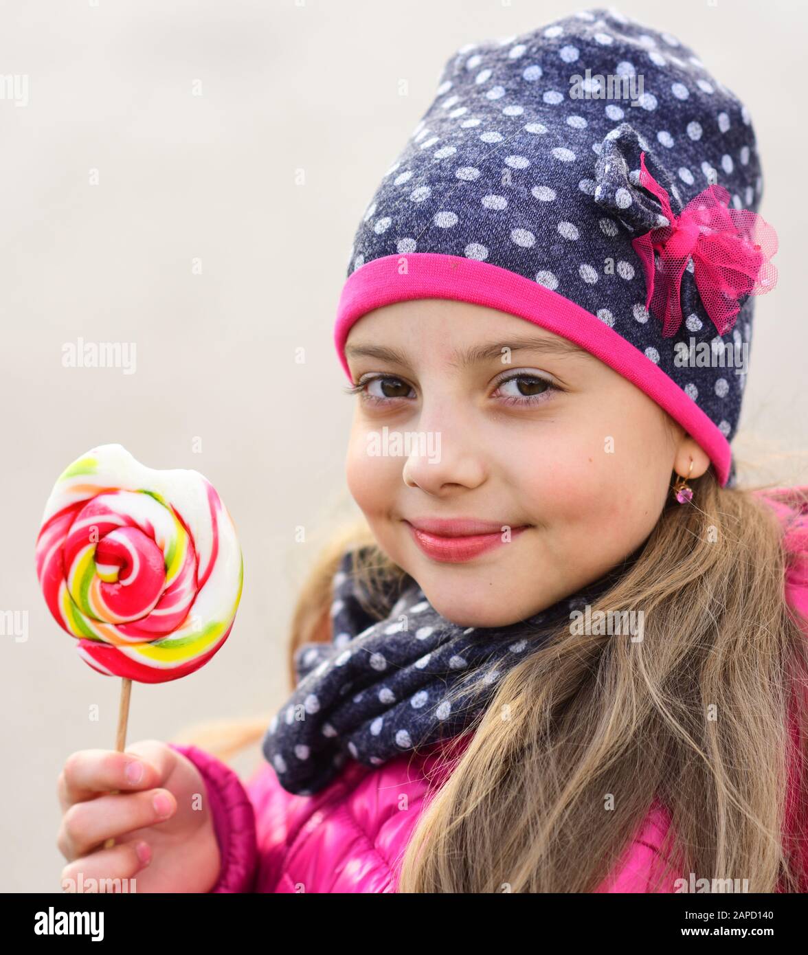 Winter candies concept. Lady with smiling face poses with candy on ...
