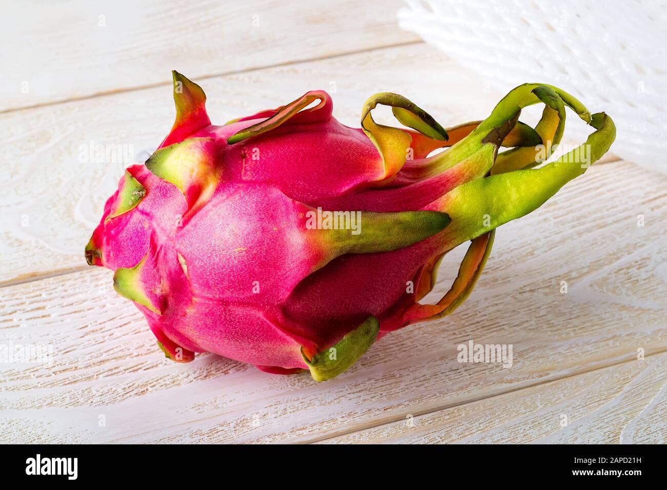 Whole dragon fruit or pitaya on a white wooden table. Fruits and ...