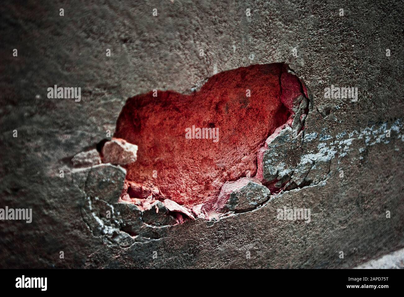 Red Heart shape in stone wall Stock Photo - Alamy