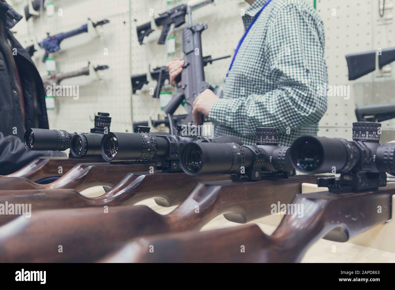 Buyer and seller at the counter of a gun shop. Weapons Stock Photo - Alamy