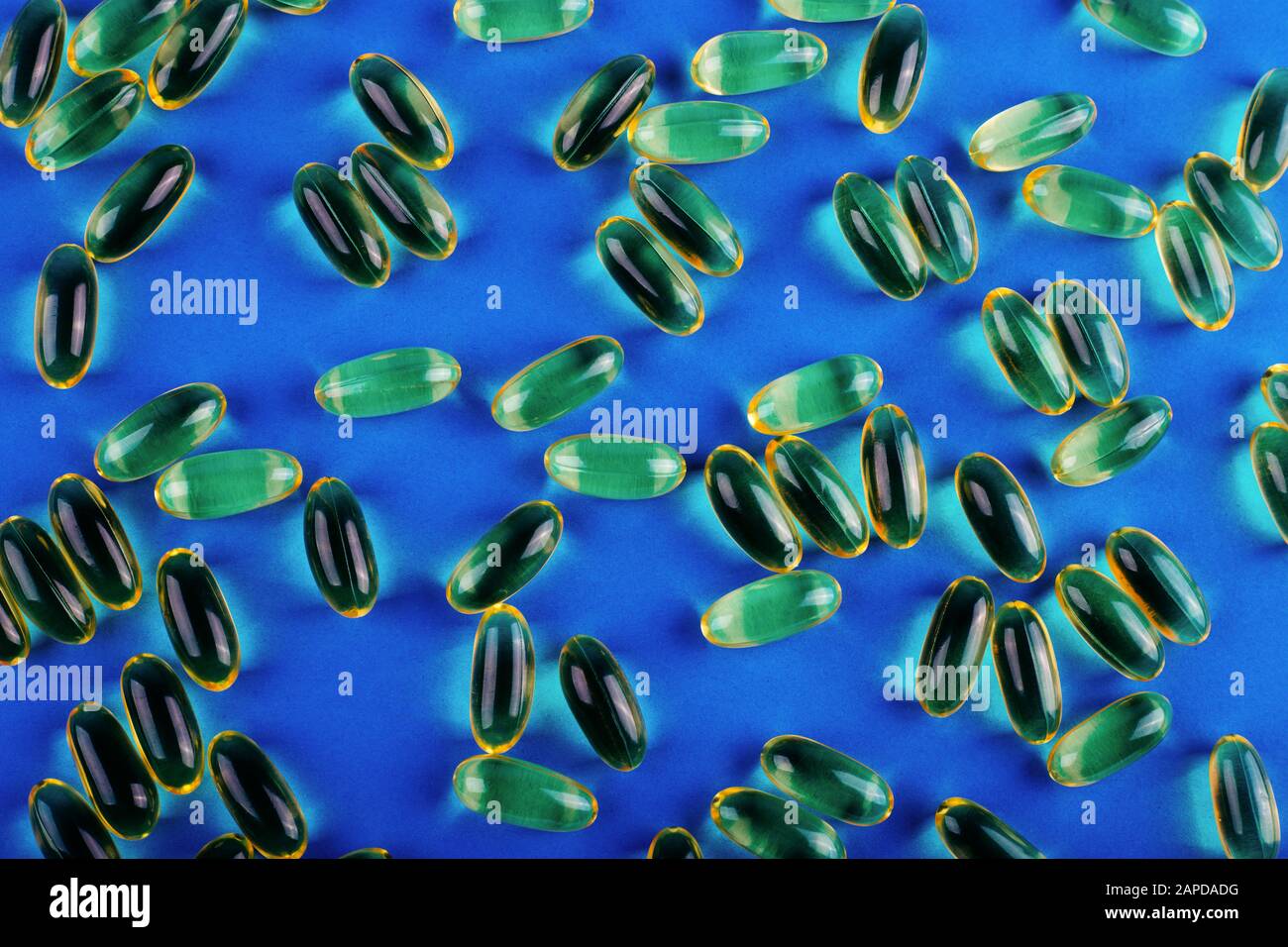 Omega 3. Fish oil capsules on blue background and texture, vitamin D ...