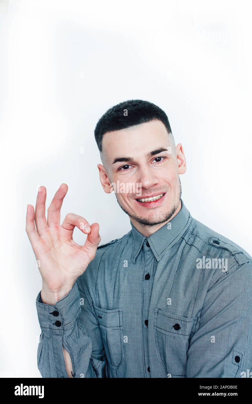 young handsome well groomed guy posing on white background gesturing ...