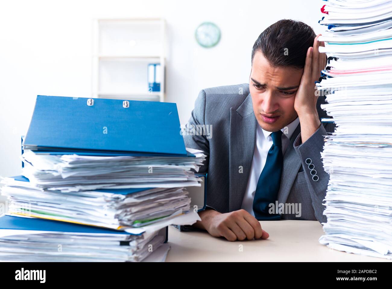 The businessman with heavy paperwork workload Stock Photo - Alamy
