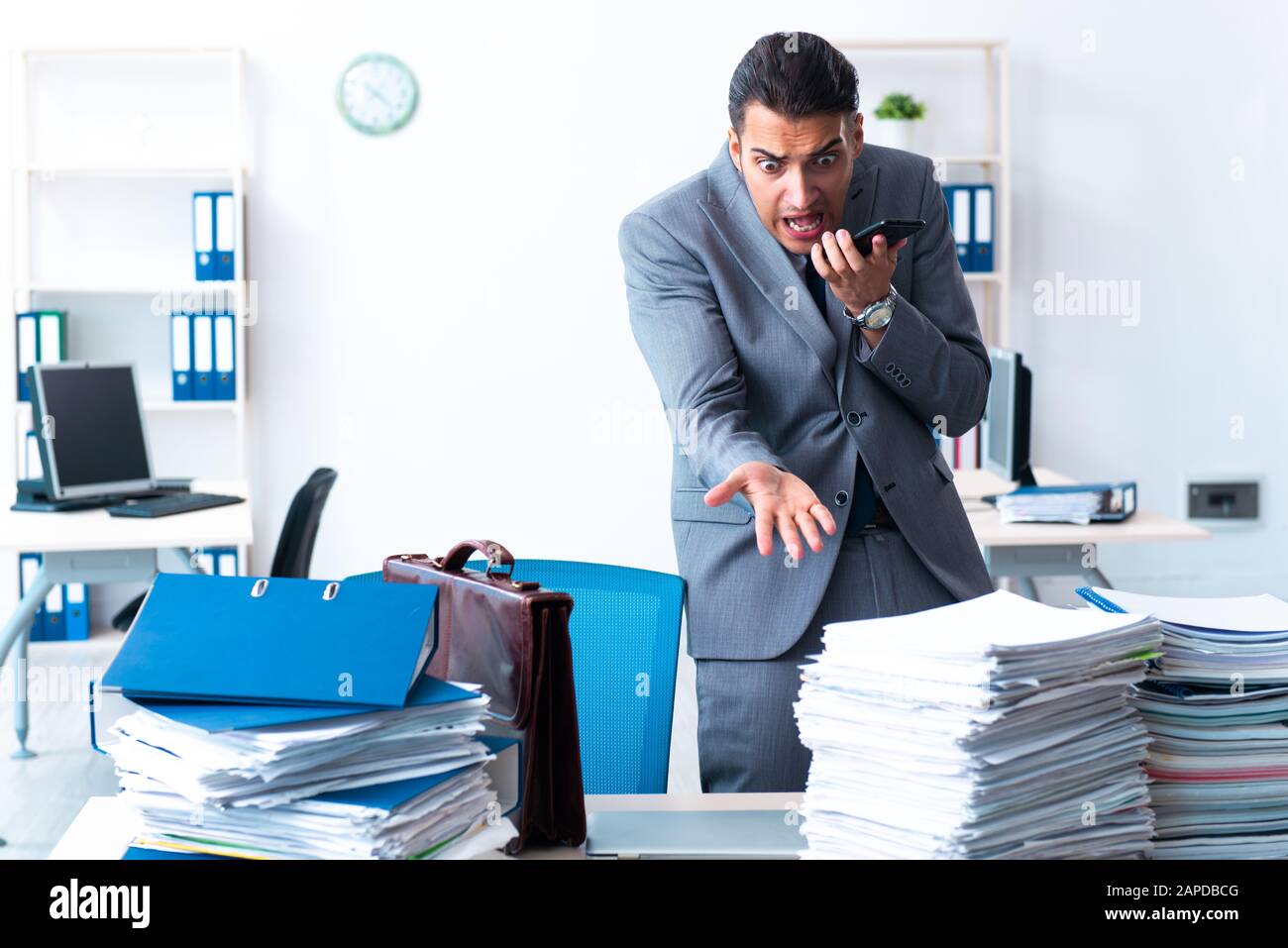 The businessman with heavy paperwork workload Stock Photo - Alamy