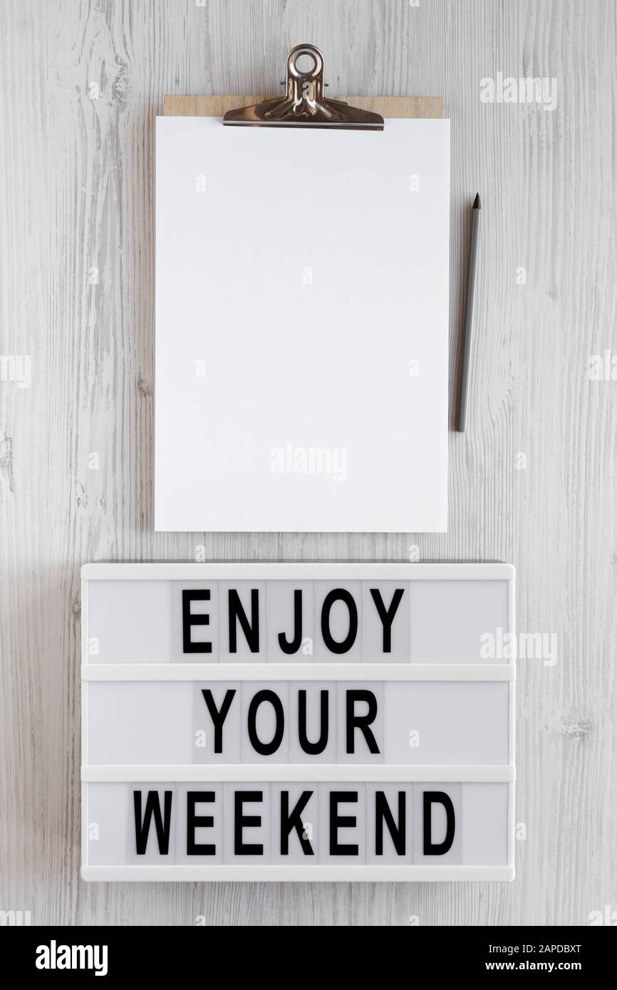 'Enjoy your weekend' words on a modern board, clipboard with blank ...