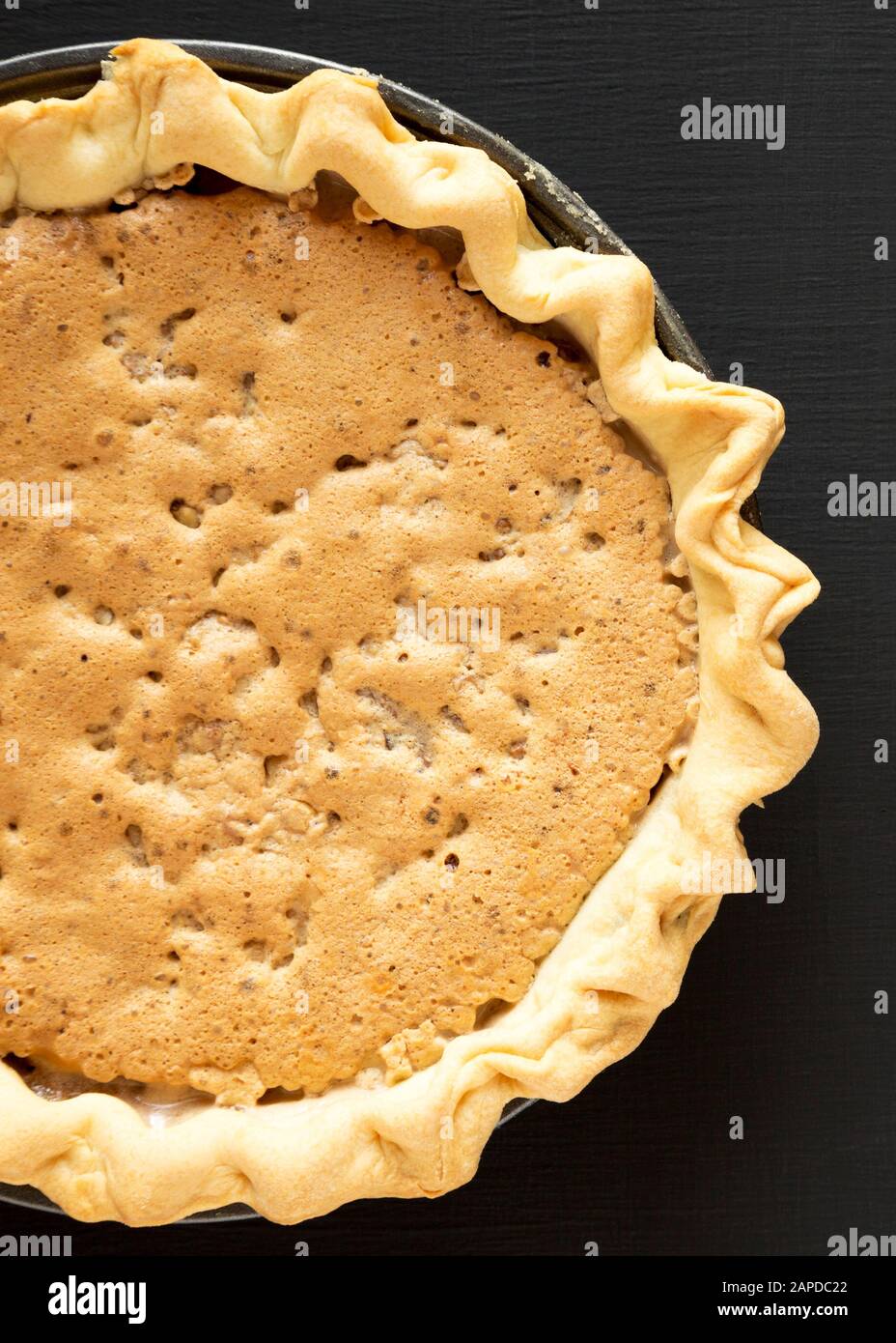 Homemade Chocolate Walnut Derby Pie over black surface, top view. From ...