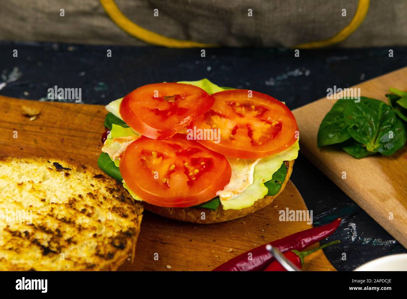 Process of cooking burgers. Cropeed view of chef hands in black gloves ...