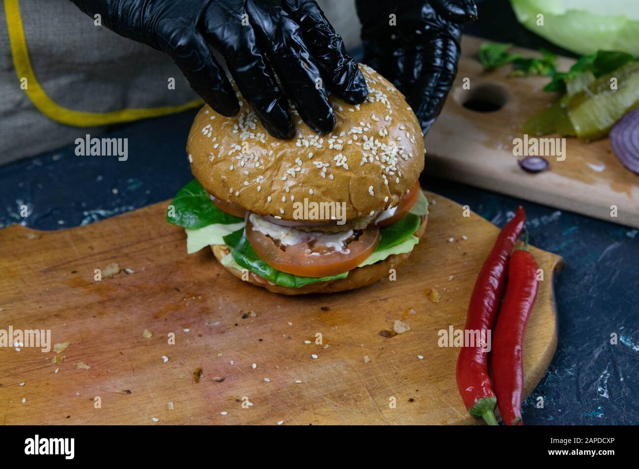 Process of cooking burgers. Cropeed view of chef hands in black gloves ...