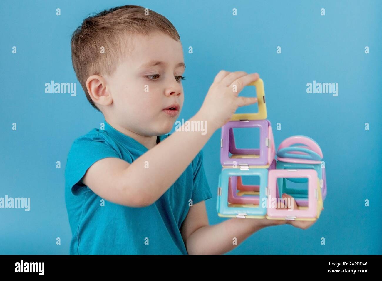 Boy looks through the shape in the color constructor with the ...