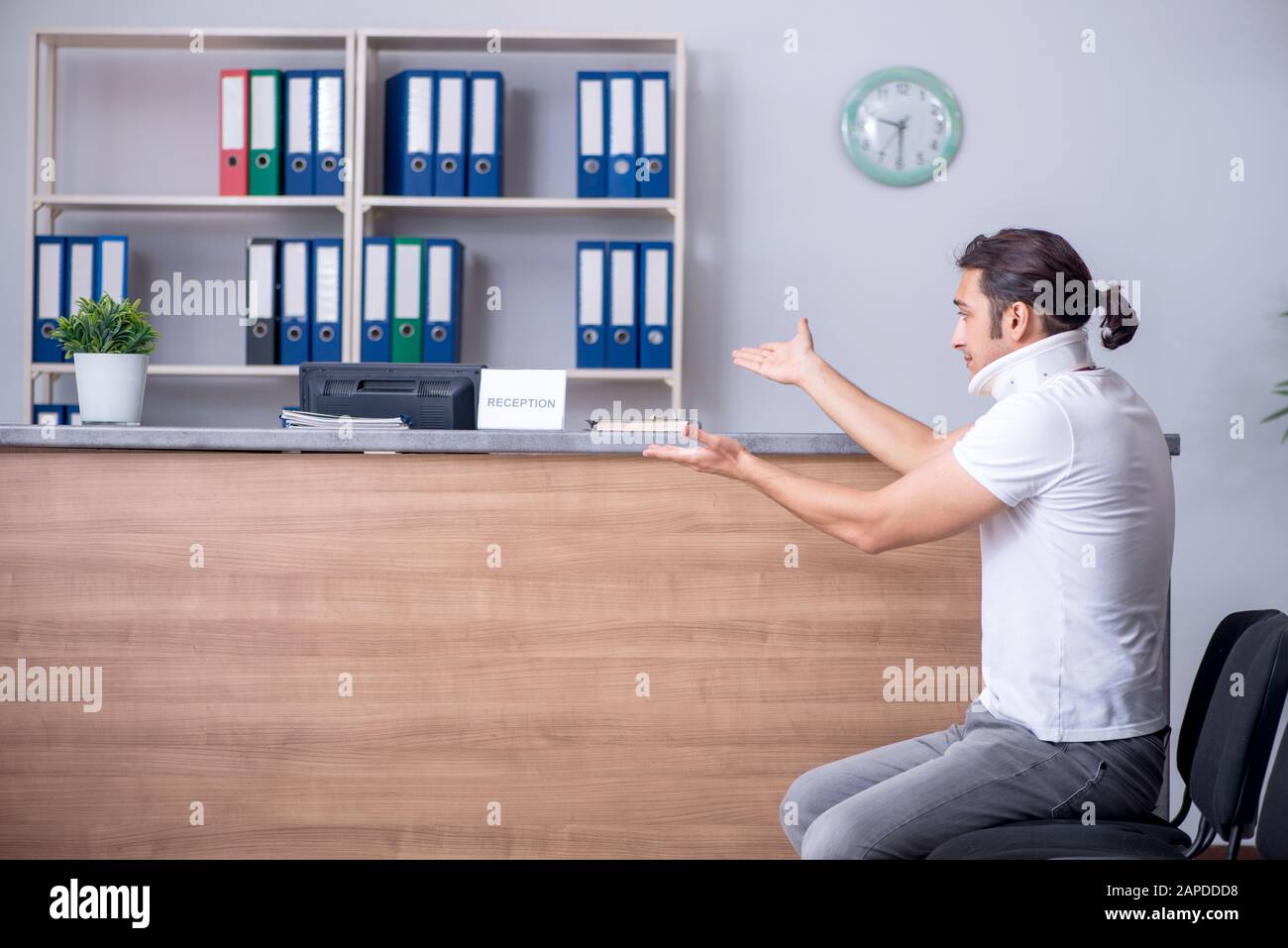 Clinic reception counter and young patient Stock Photo - Alamy
