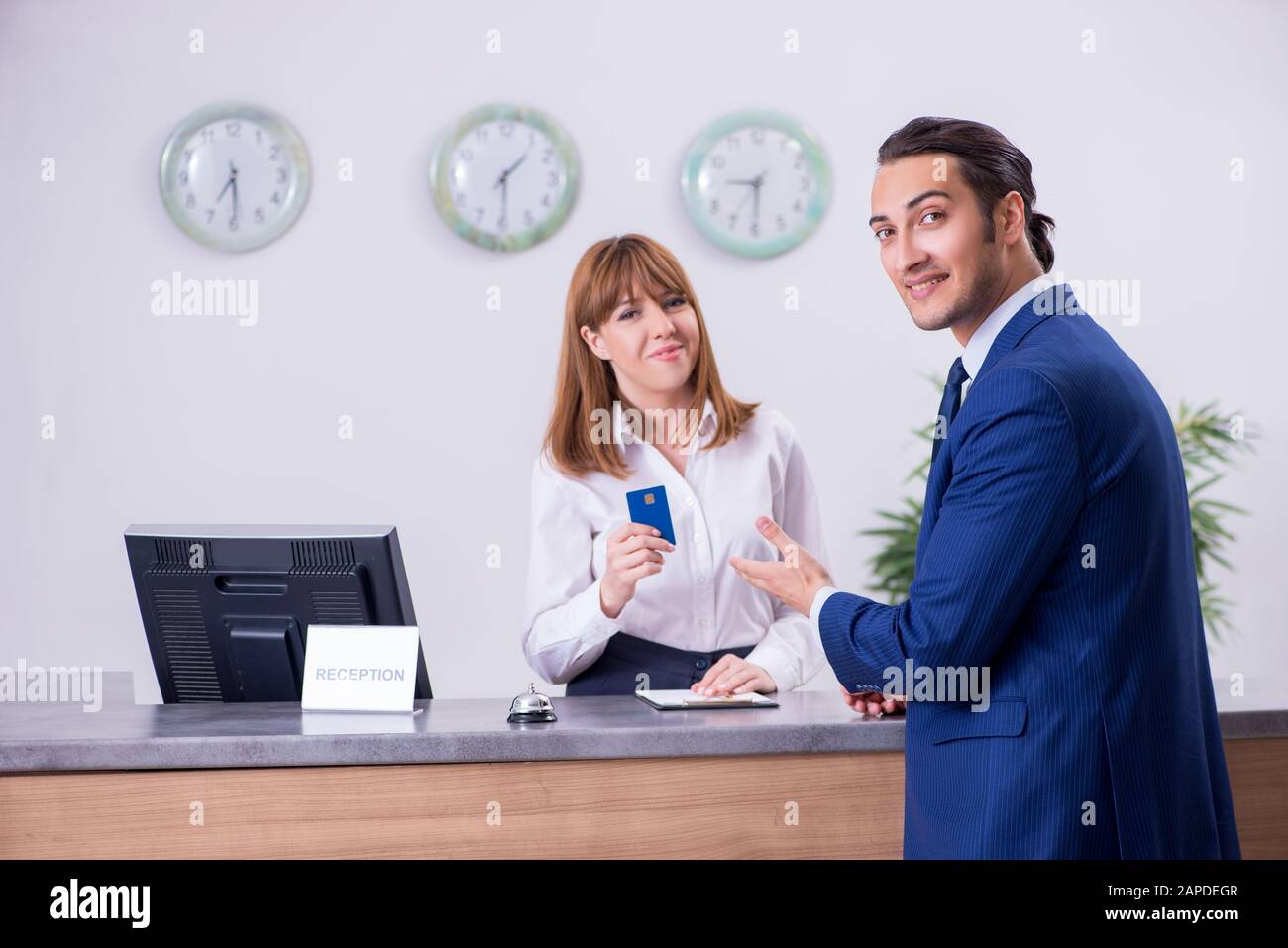 The young businessman at hotel reception Stock Photo - Alamy