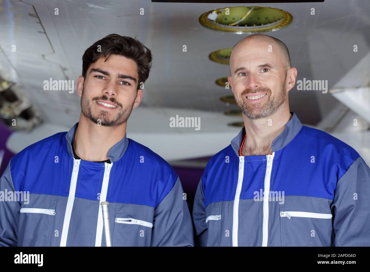 two laborers in blue overalls Stock Photo - Alamy