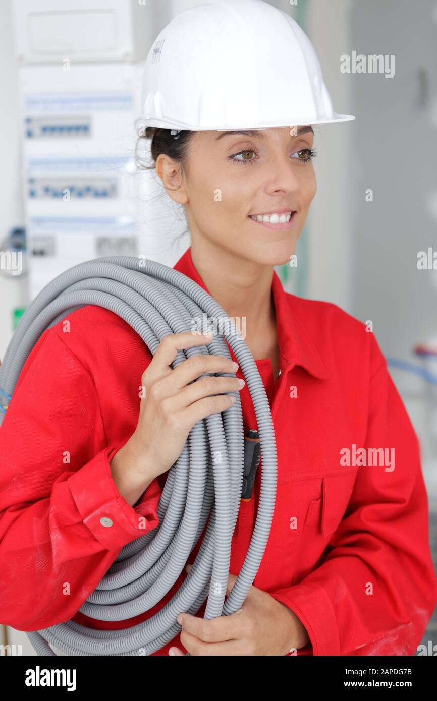 woman in overalls holding cables Stock Photo - Alamy