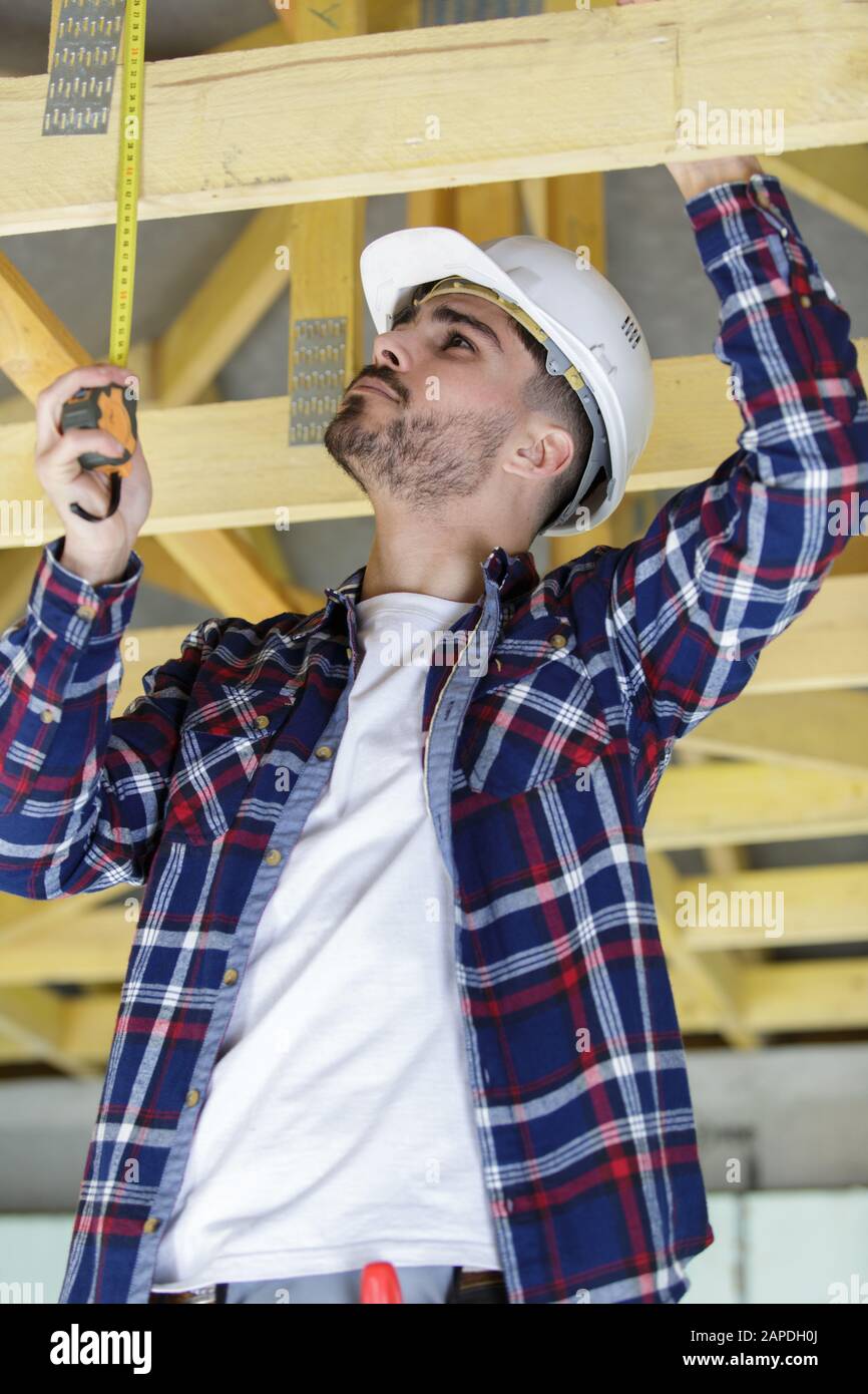 builder measuring new wooden beam Stock Photo - Alamy