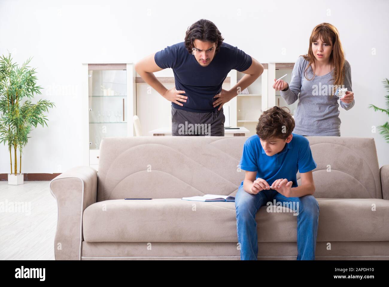 The concept of underage smoking with young boy and family Stock Photo ...