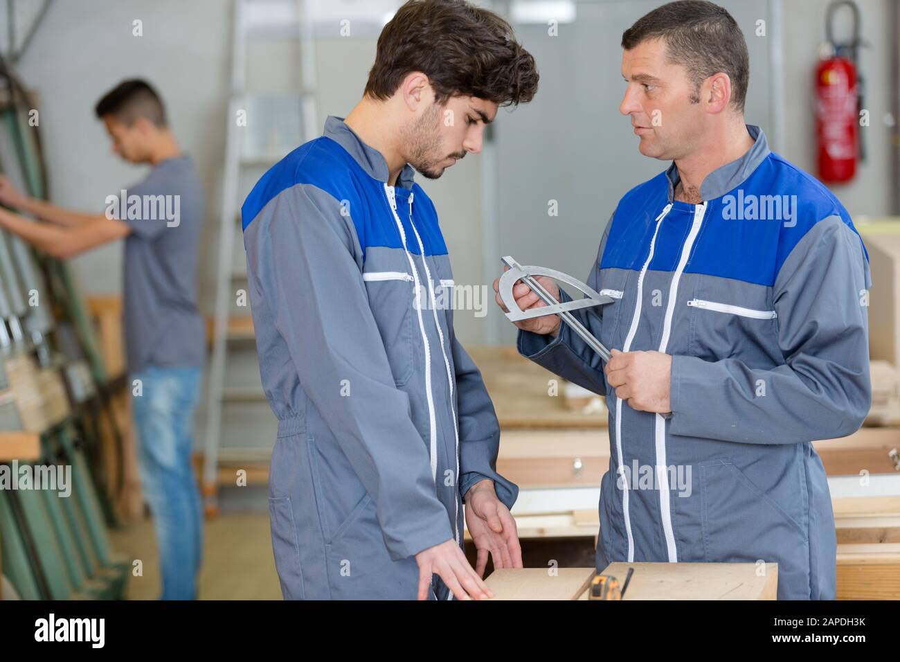 industrial workers using a protractor at factory workshop Stock Photo ...