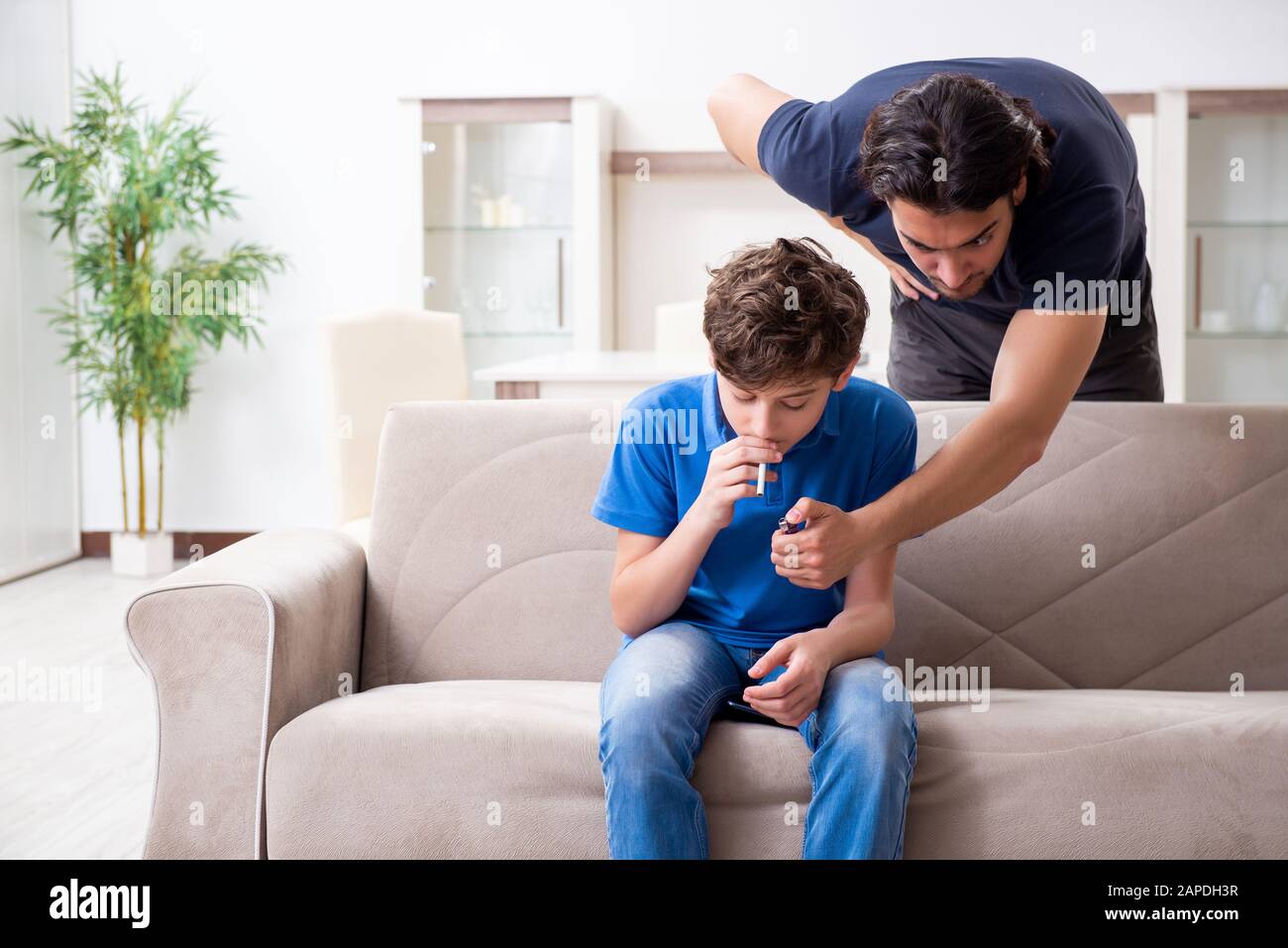 The concept of underage smoking with young boy and family Stock Photo ...