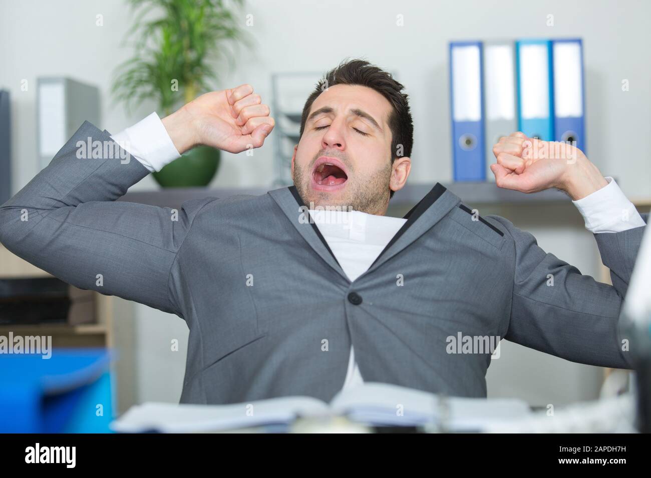 portrait of a yawning businessman Stock Photo - Alamy
