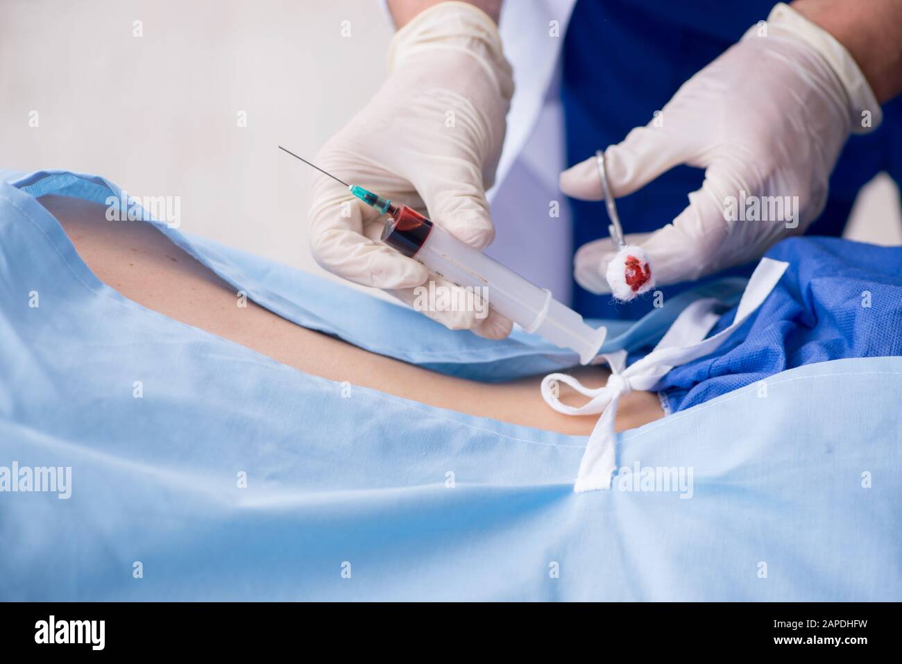 The female patient getting an injection in the clinic Stock Photo - Alamy