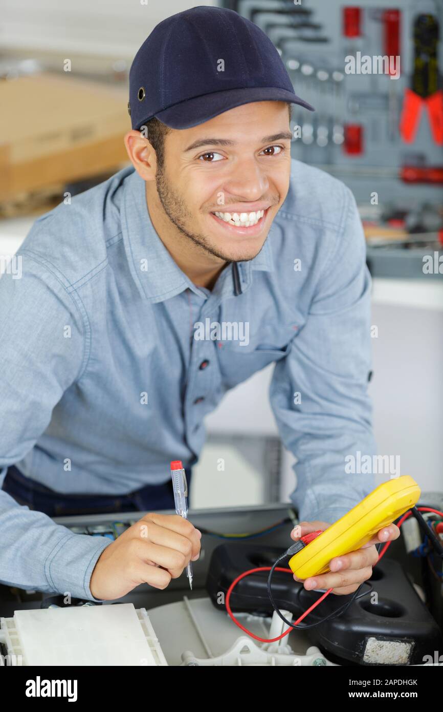 a young serviceman using multimeter Stock Photo - Alamy
