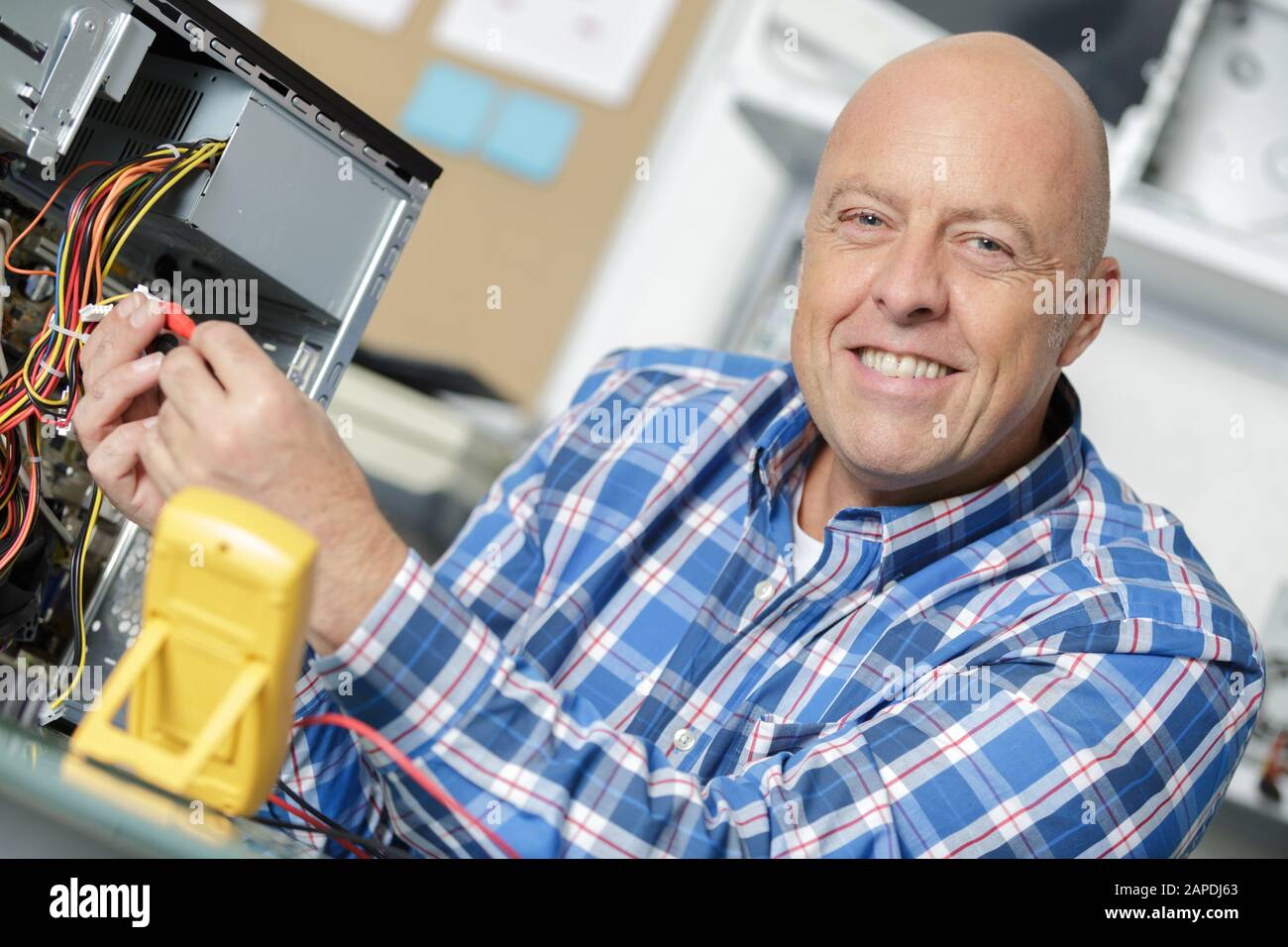 electrician measures the voltage of pc computer Stock Photo - Alamy