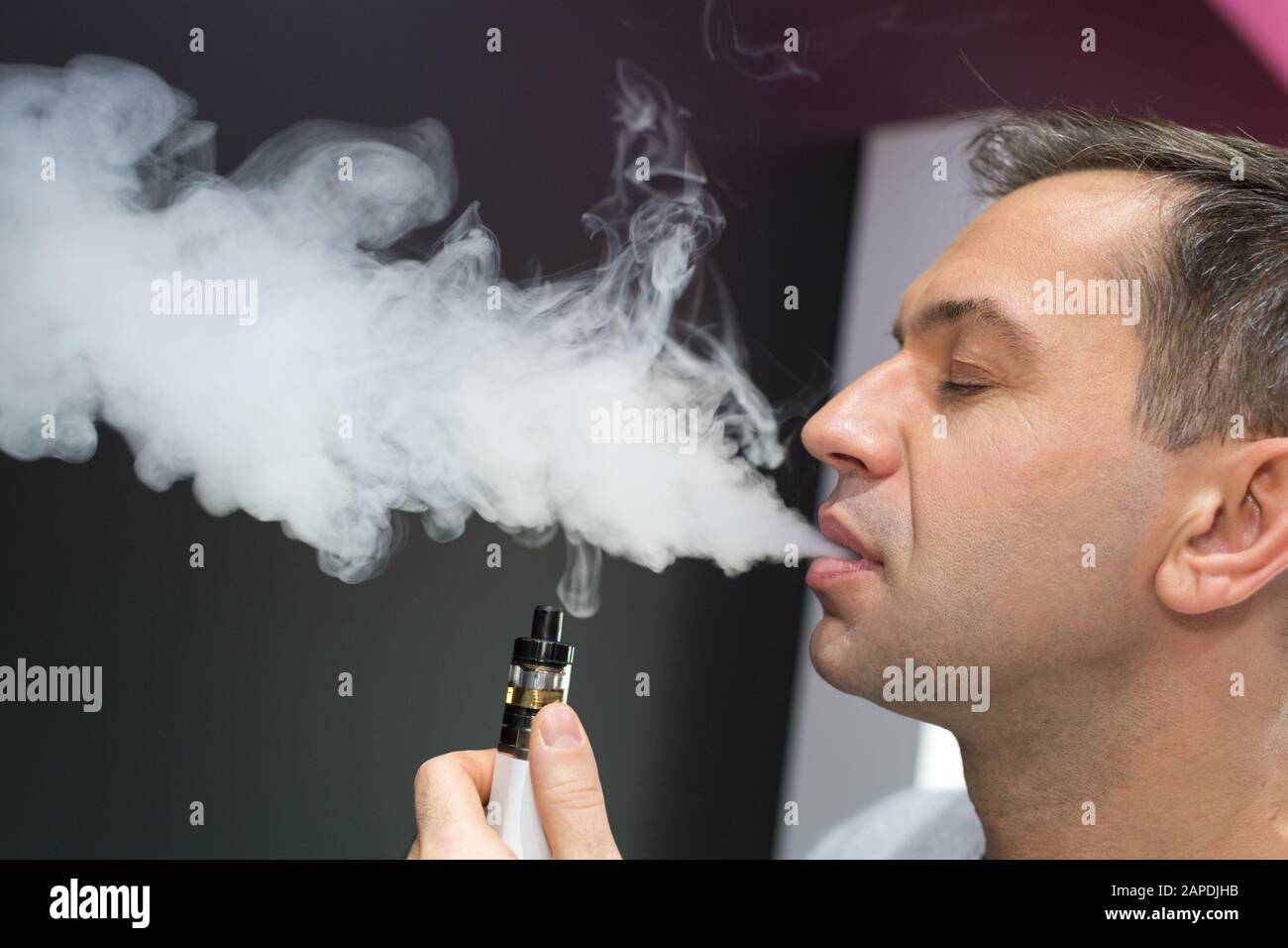 Handsome man smoking electric cigarette hi-res stock photography and ...